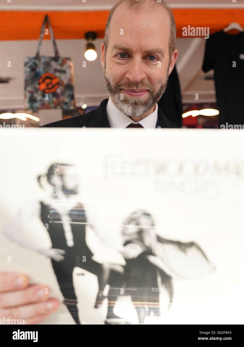 Business Secretary Jonathan Reynolds looks at a vinyl LP of Rumours by ...