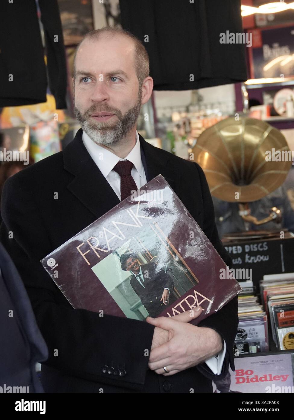 Business Secretary Jonathan Reynolds holds a vinyl LP of Frank Sinatra ...