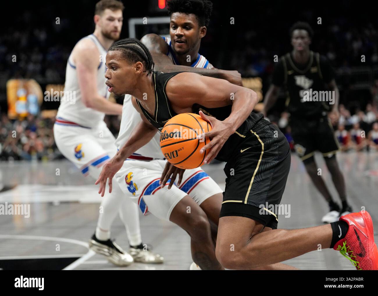 MAR 12 2025: UCF Knights guard Keyshawn Hall (4) drives past Kansas ...