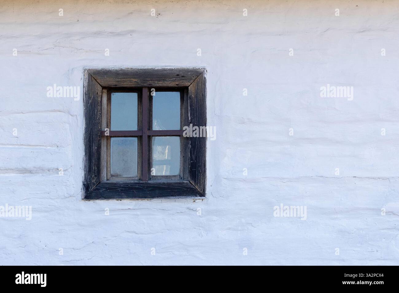 small wooden window on an old traditional romanian stone house ...