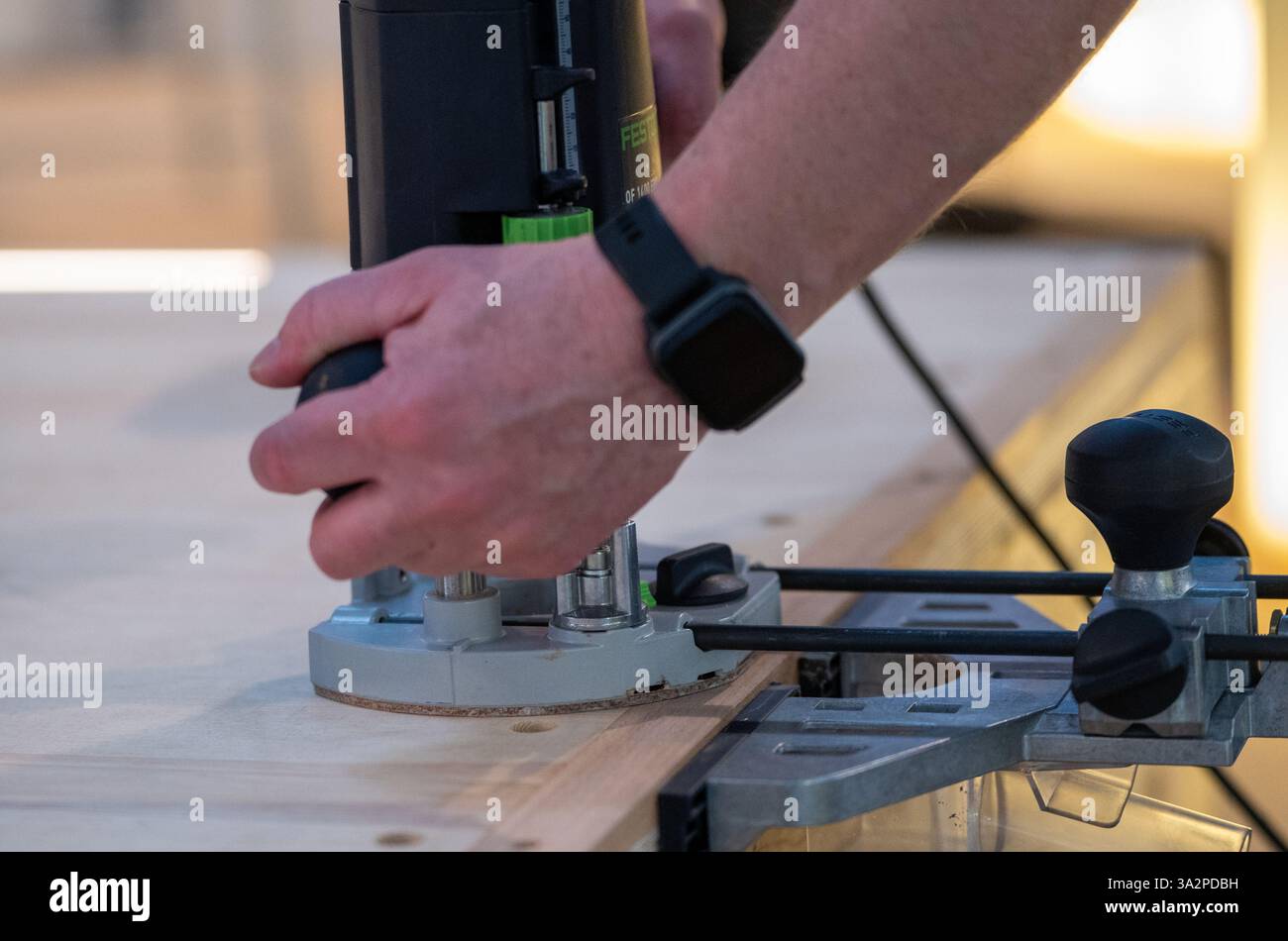 Munich, Germany. 13th Mar, 2025. A person works with a router at a ...