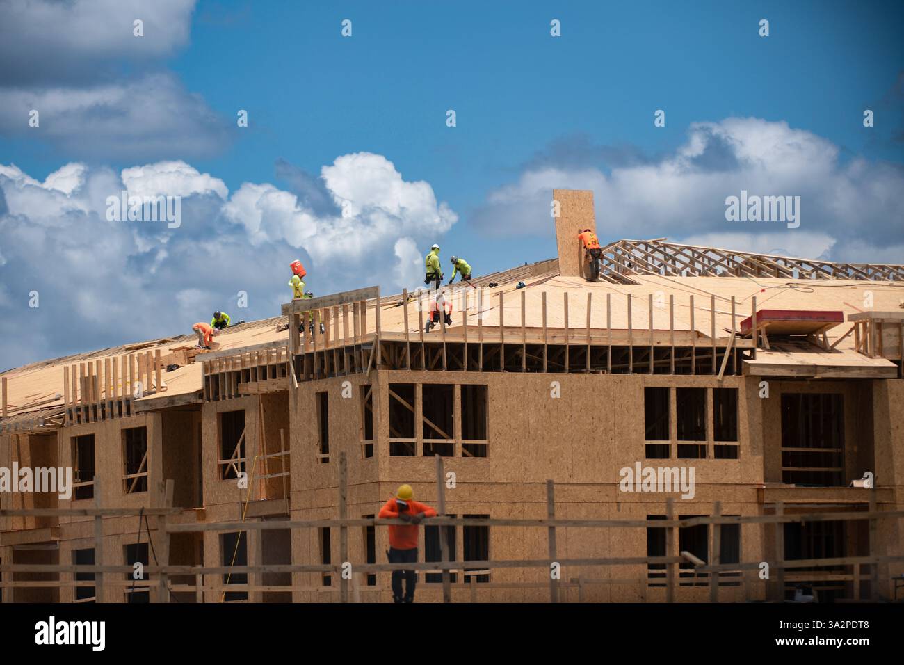 Wooden roof. Roofs repair. Construction site. Roofer worker at roof. Top roof. Big roof beams ...