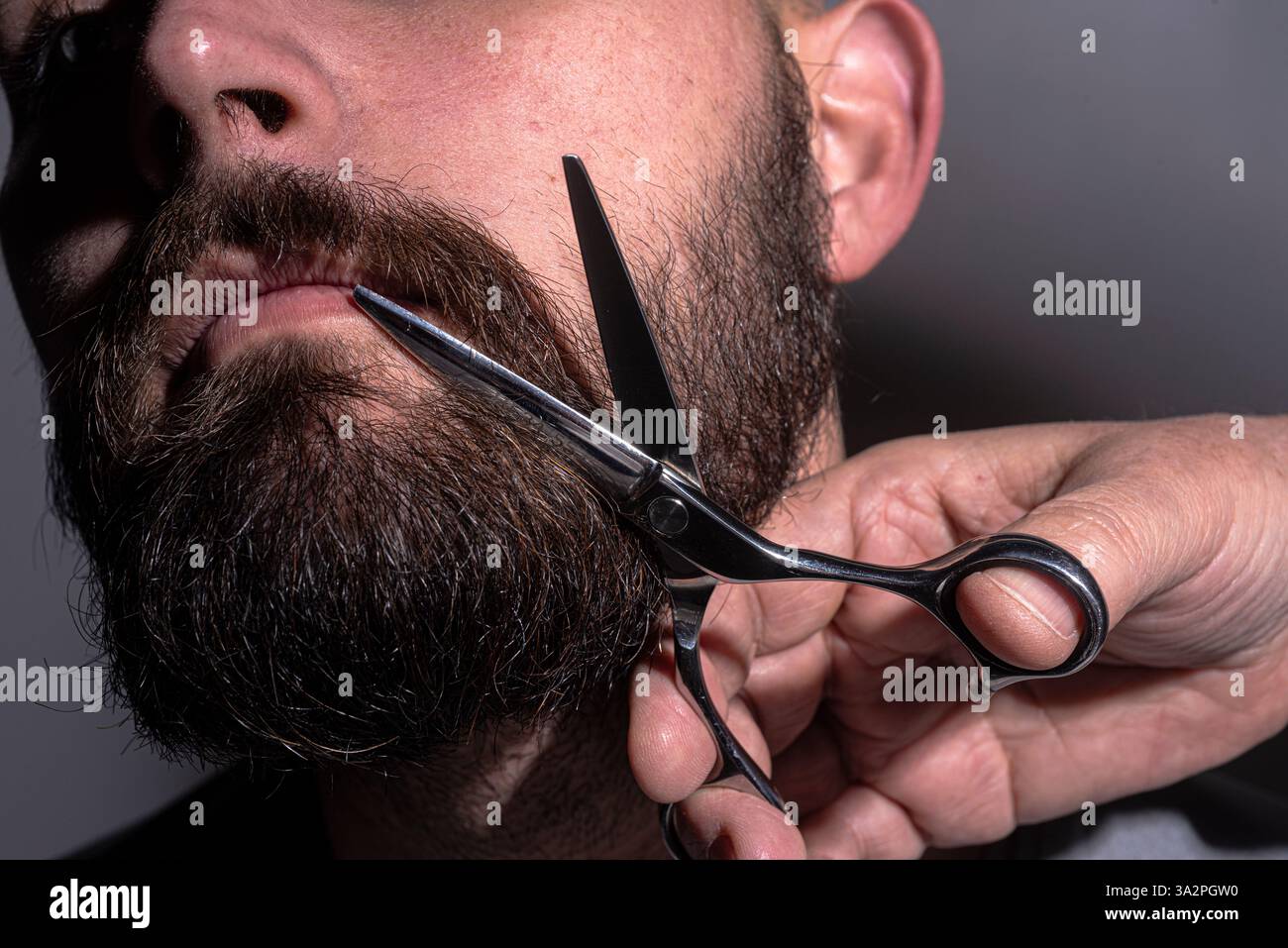 Man with barbers scissors. Man cut hair with hairdressing scissors. Men ...