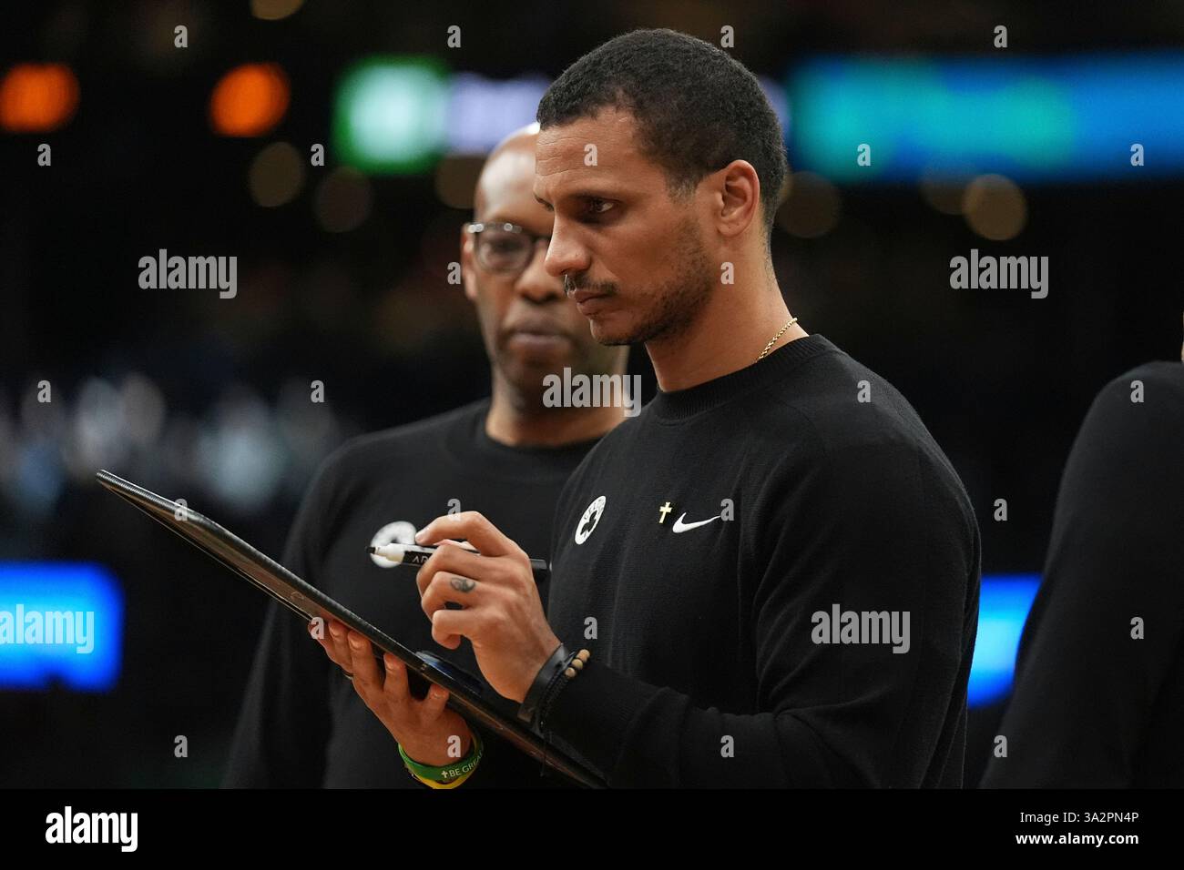 Boston Celtics head coach Joe Mazzulla draws a play as assistant coach ...