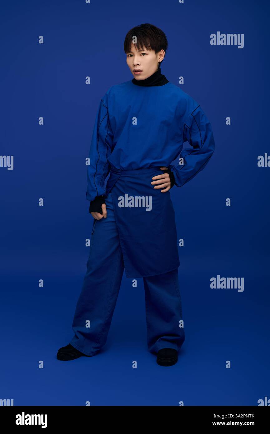 A stylish young asian man showcases his charisma in a blue ensemble ...