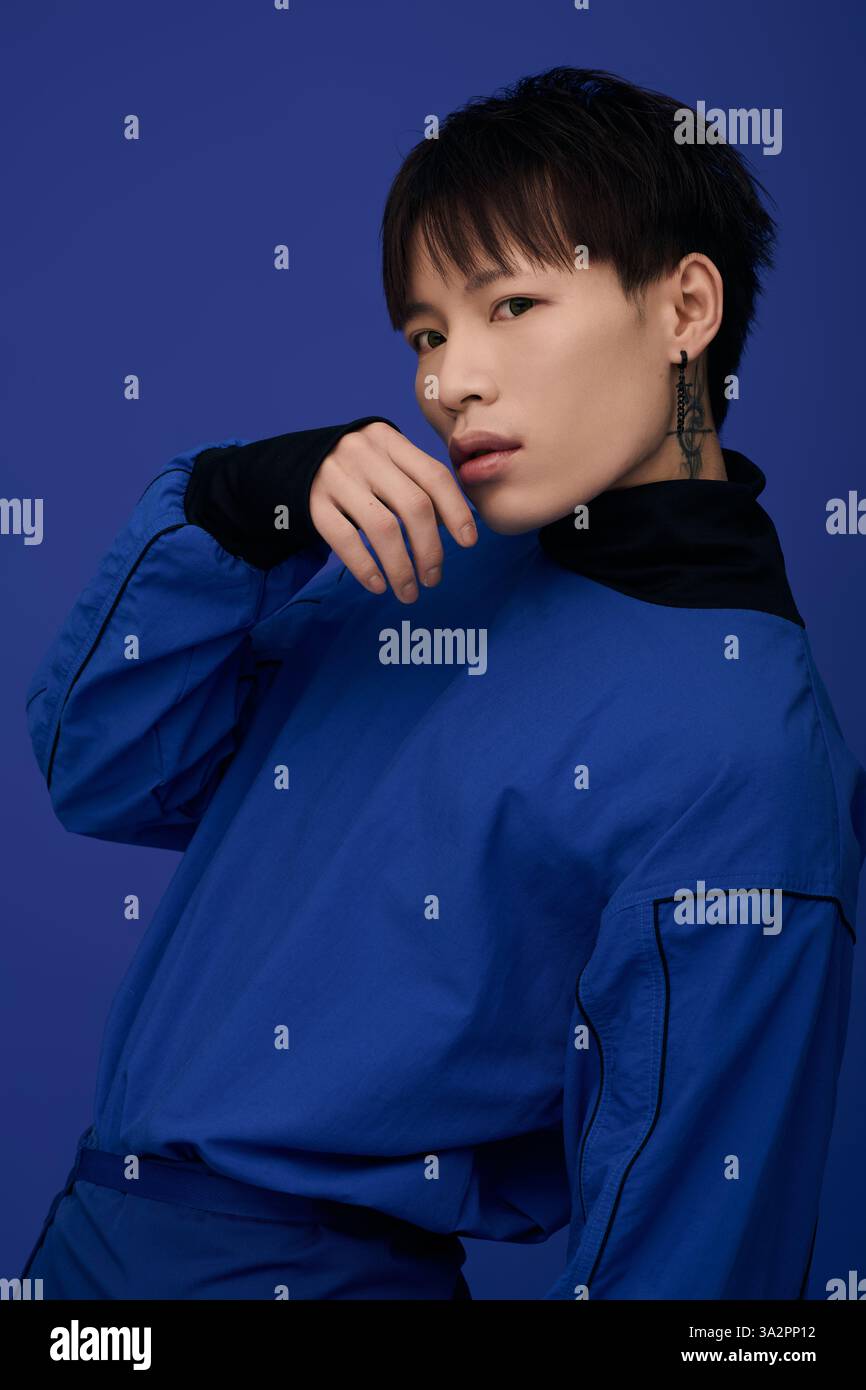 A handsome young asian man showcases a stylish blue outfit, exuding ...