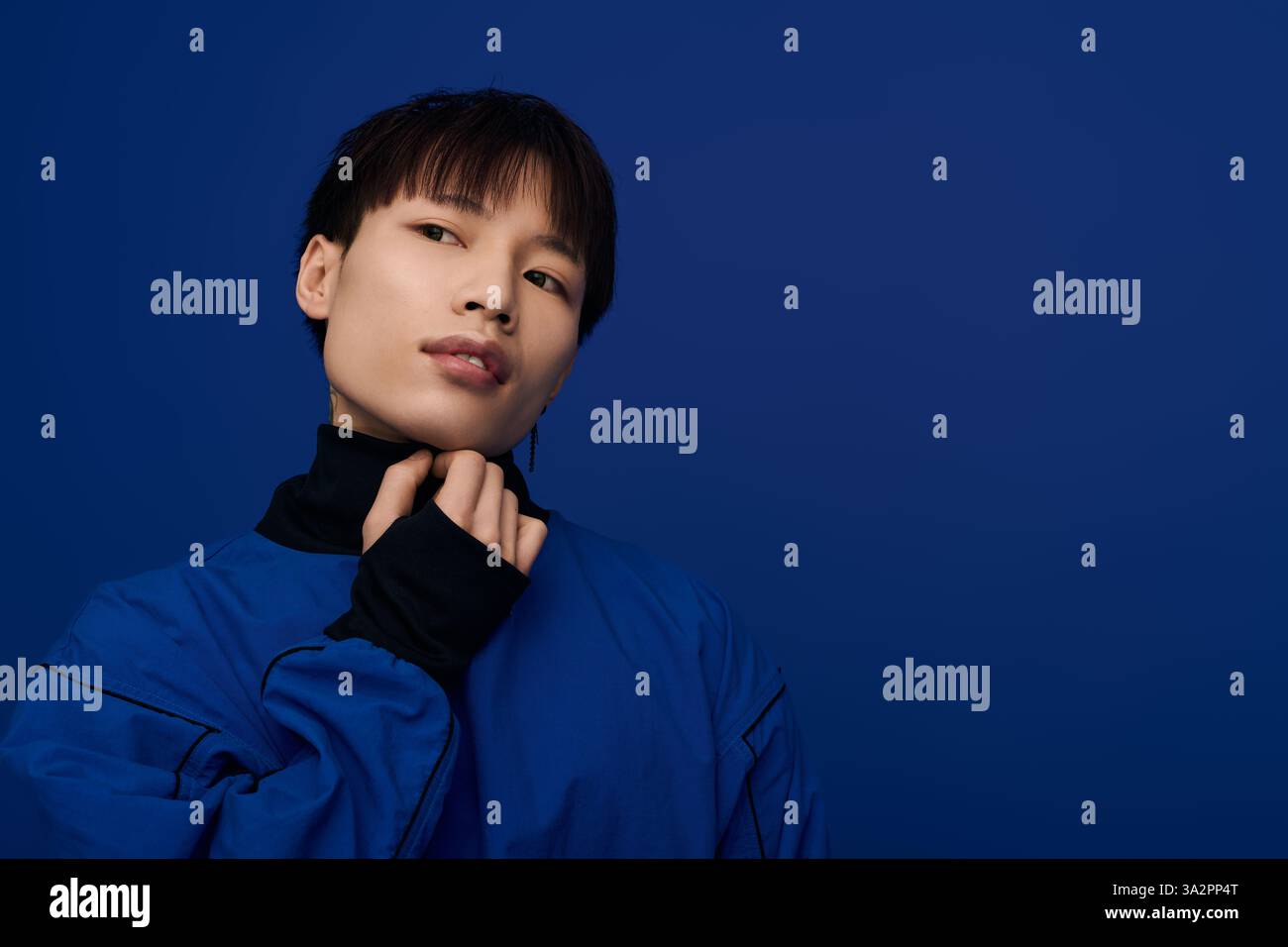 Charming young asian man in a stylish outfit exudes confidence with a ...