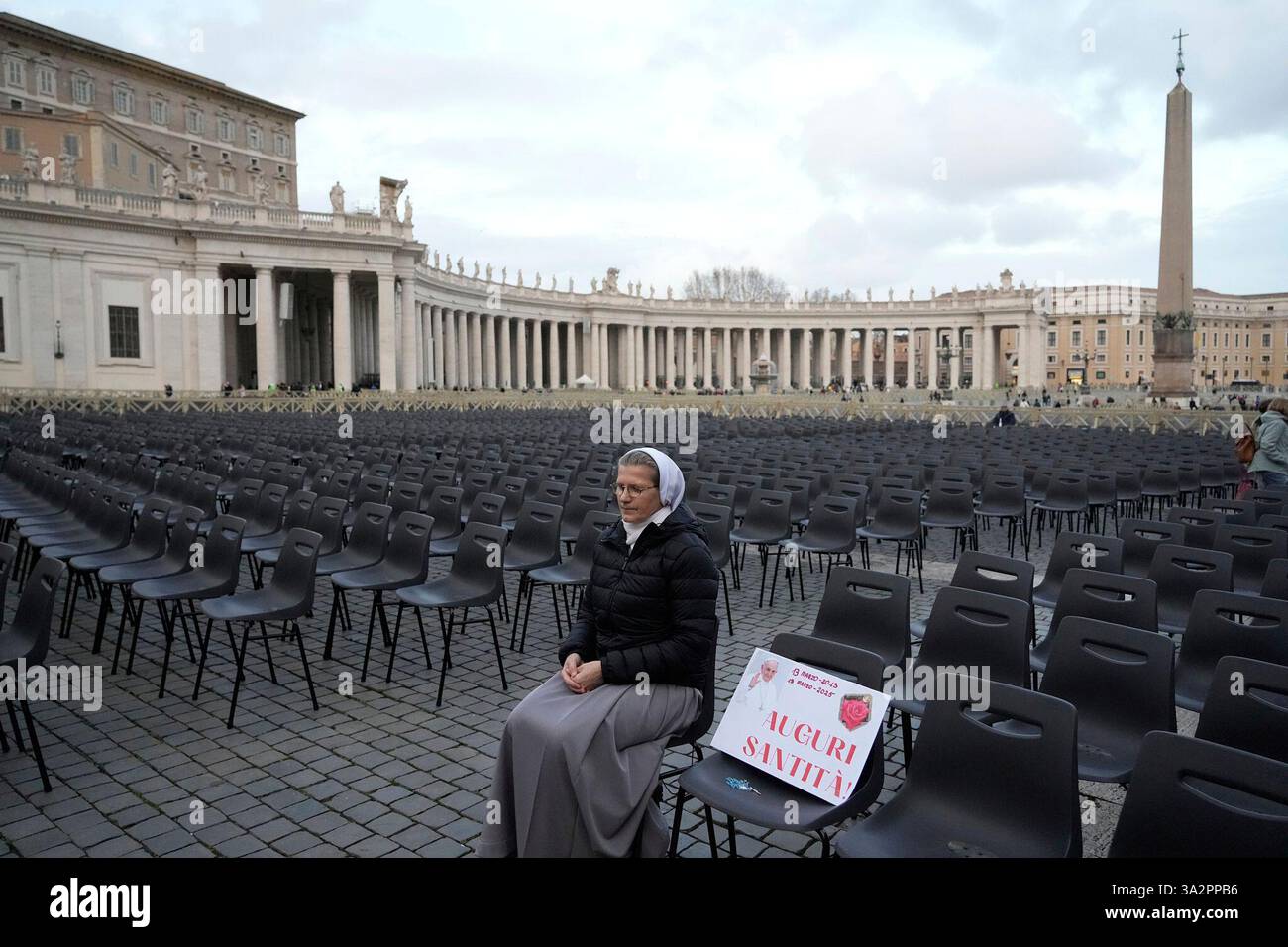 Sister Veronika Mroz, of Poland, sits beside a placard with a picture ...