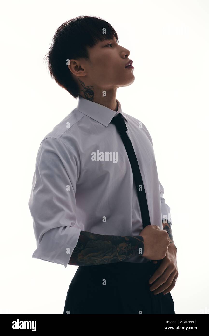 A confident young Asian man flaunts his charm in a tailored shirt and ...