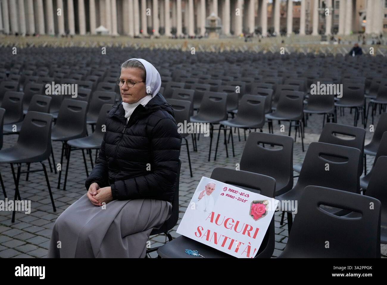 Sister Veronika Mroz, of Poland, sits beside a placard with a picture ...