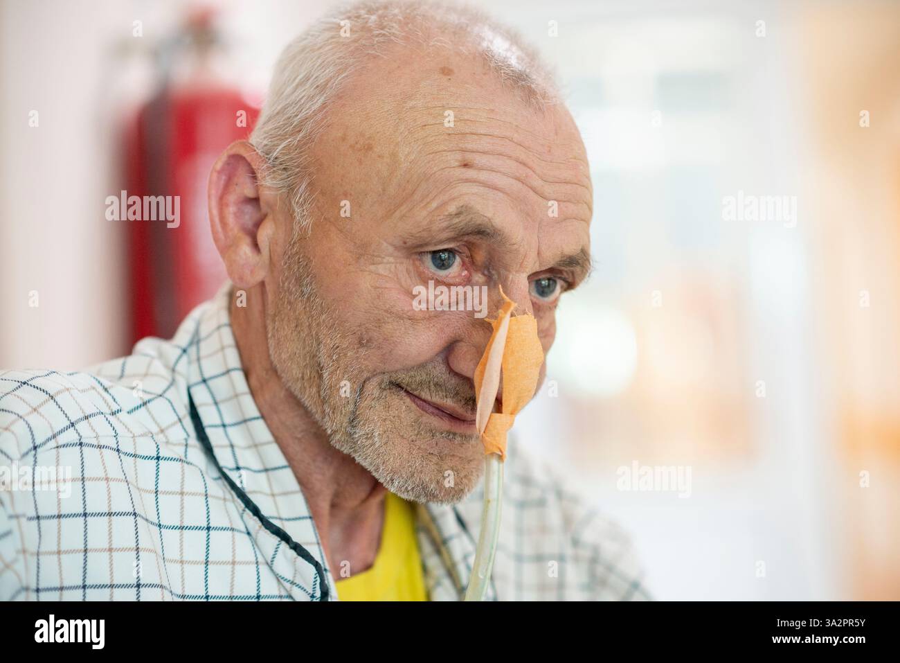 Patient with nasogastric tube on hospital bed waiting for treatment ...