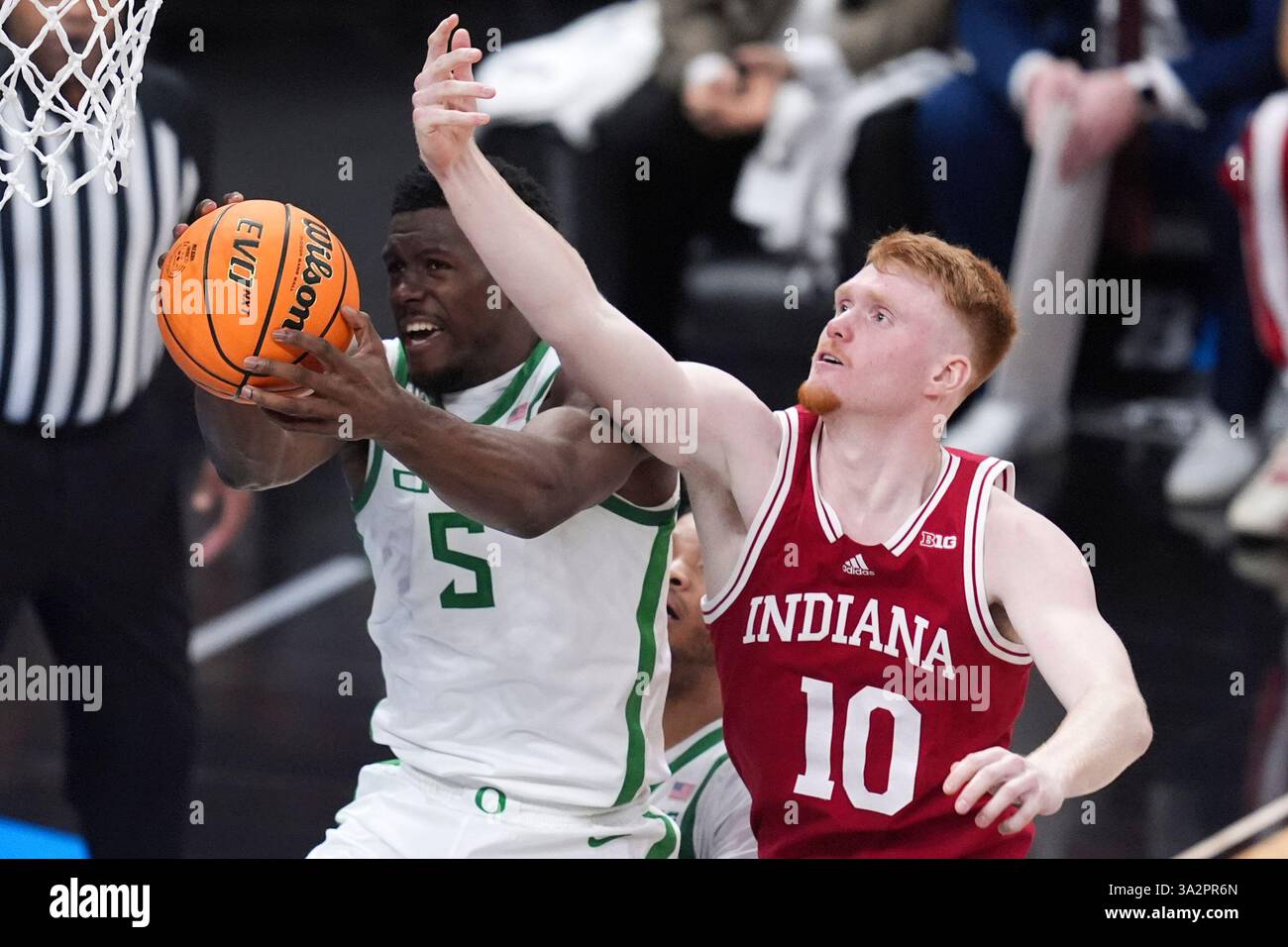 Oregon guard TJ Bamba (5) pulls down a rebound from Indiana forward ...