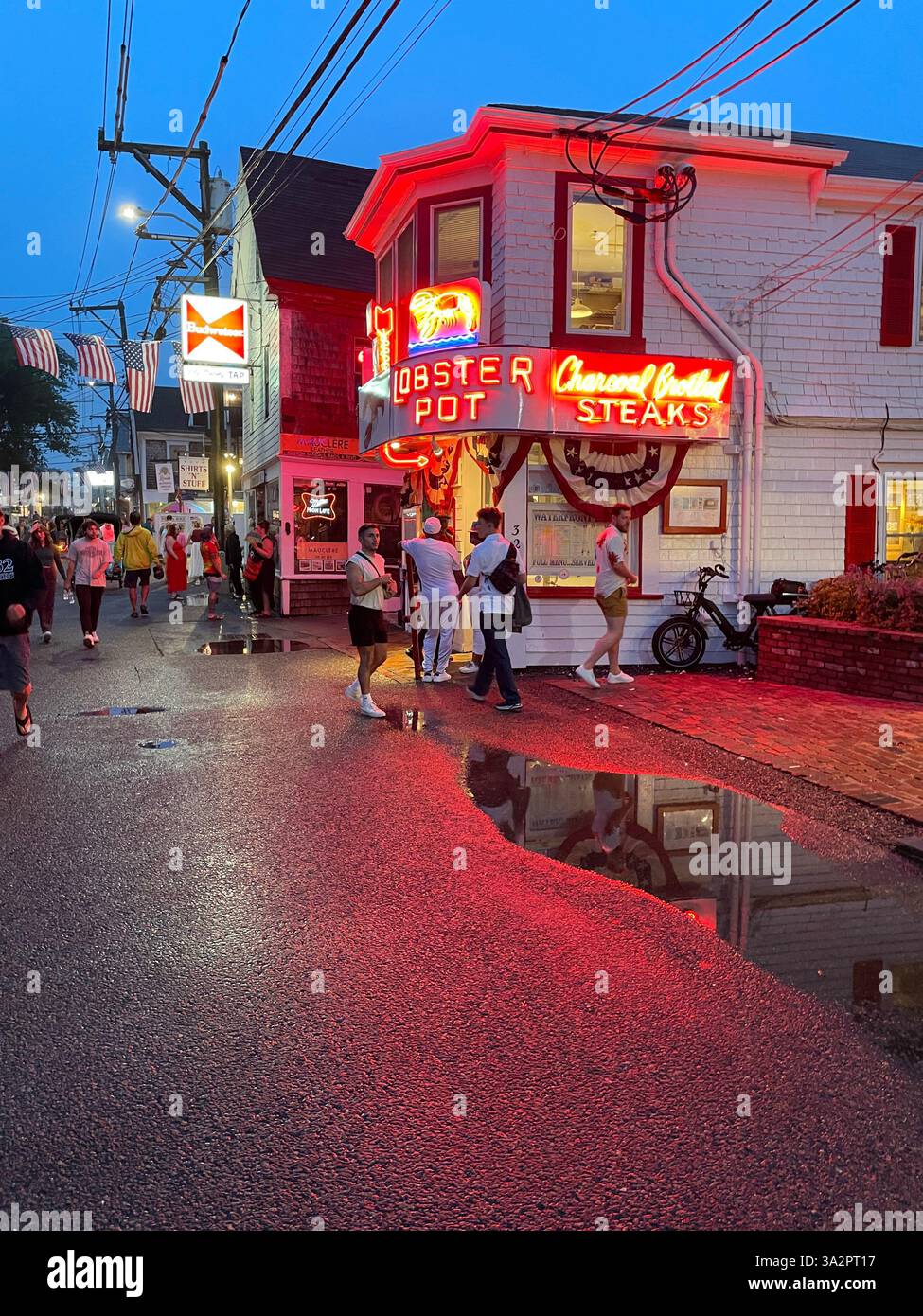 On a summer evening people walk on Commercial Street in Provincetown ...