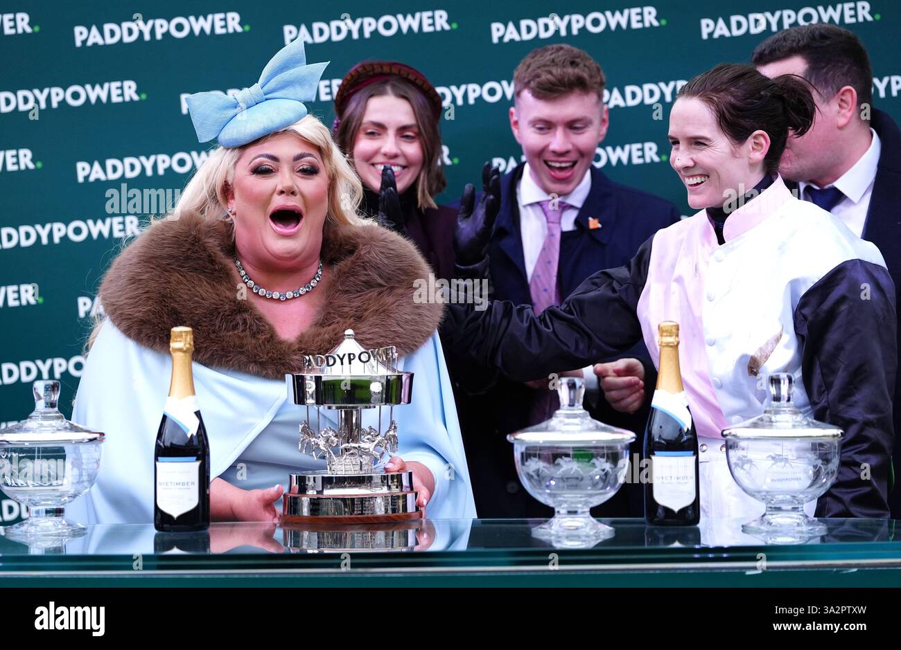 Rachael Blackmore (right) is presented with the trophy by television ...