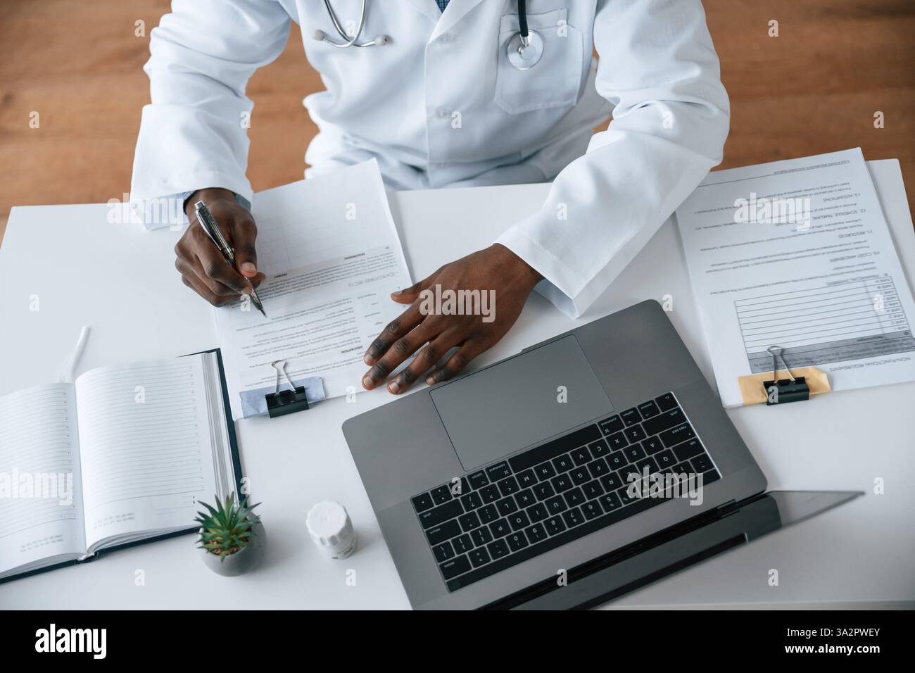 Black man as doctor in the clinic office Stock Photo - Alamy