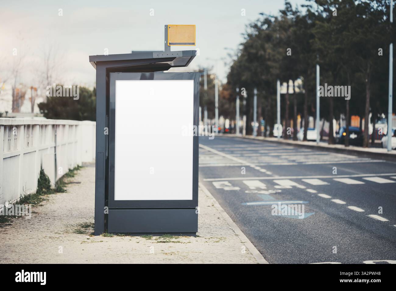 Modern bus stop with a blank vertical advertising billboard mock-up on ...