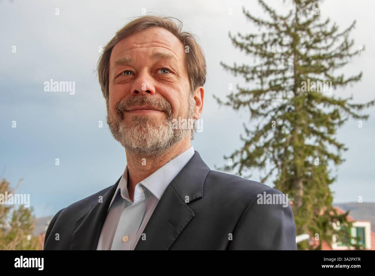 Portrait of a confident elderly man 50-55 years old with a beard in a ...