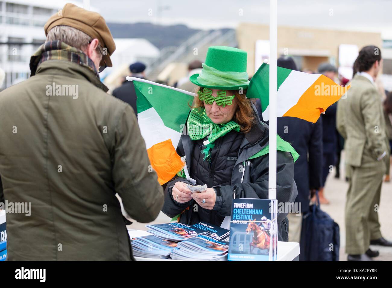 Cheltenham, England. March 13, 2025. A lady dress in Irish fancy dress ...