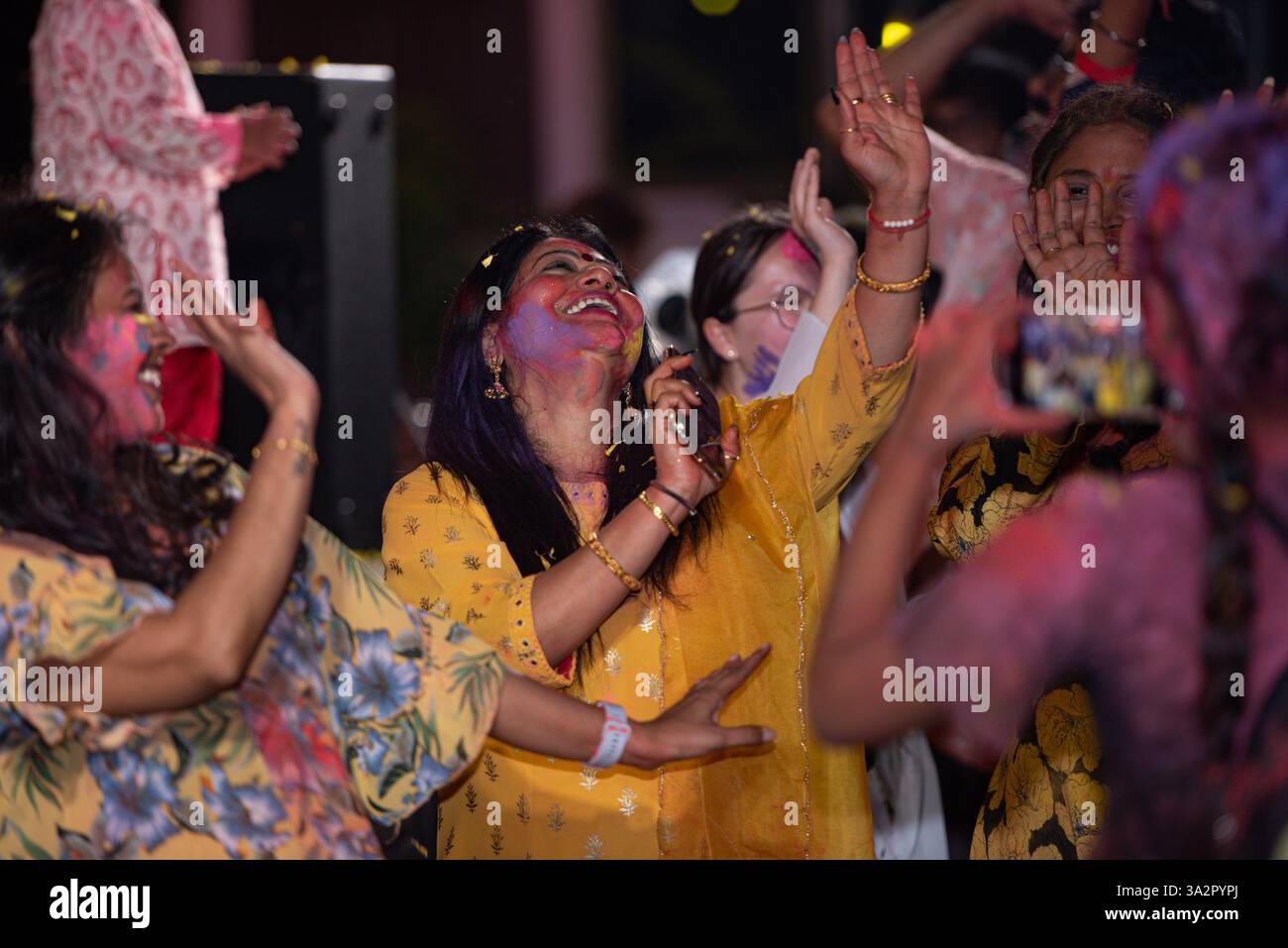 Bangkok, Thailand. 13th Mar, 2025. People dance and throw brightly ...