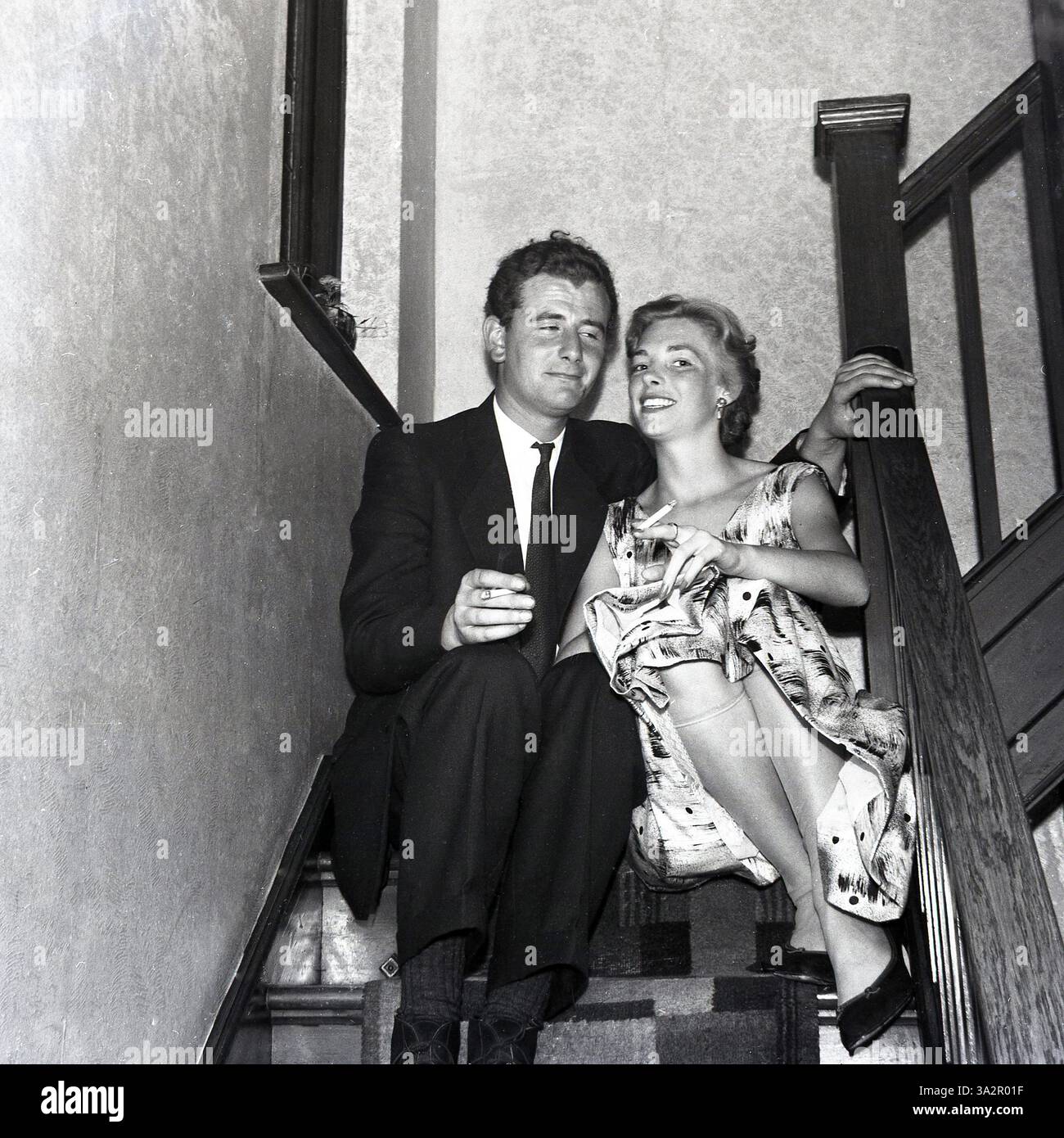 1955, historical, a man in a suit & tie, bleary eyed, with a young lady ...