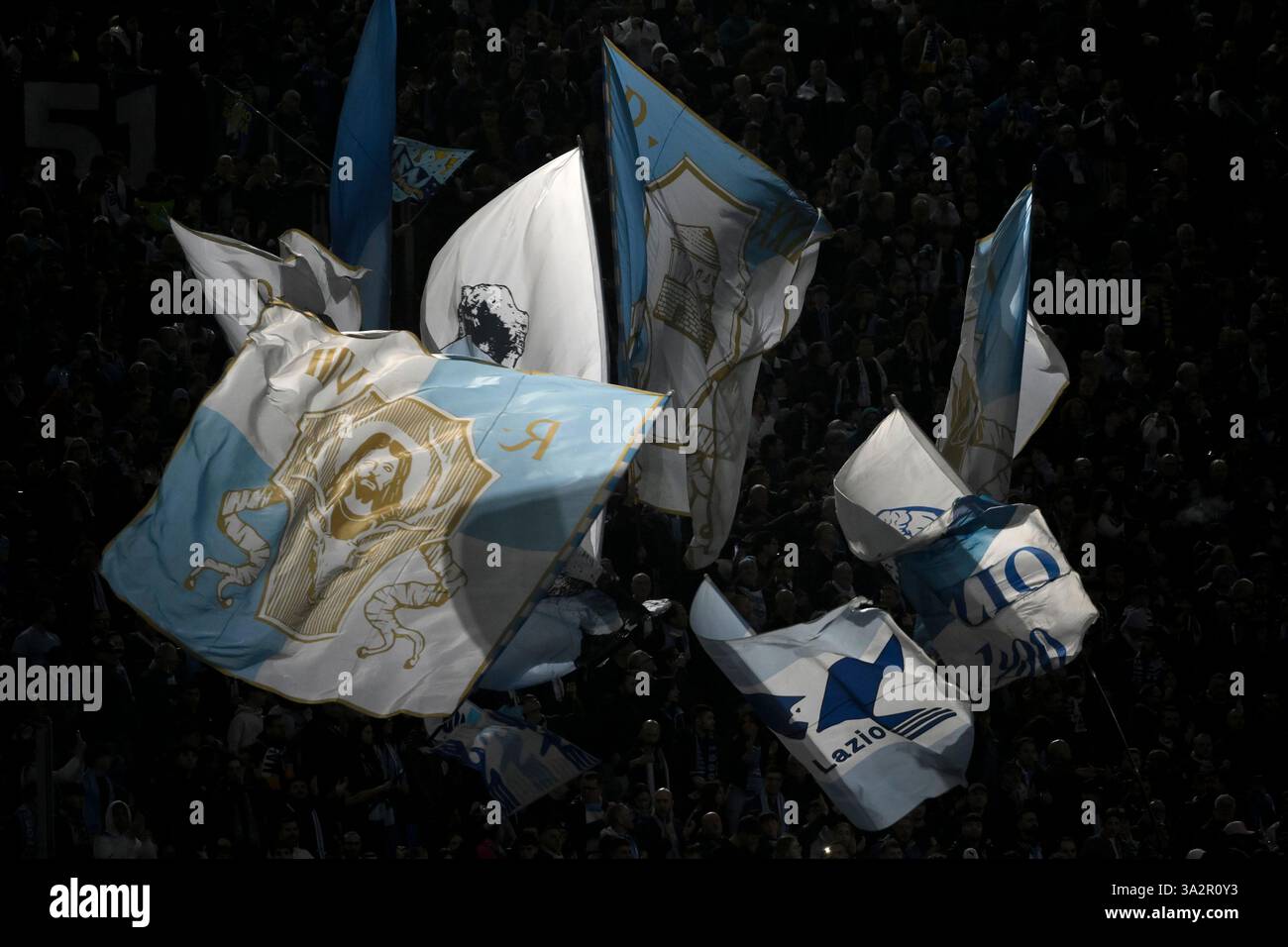 Rome, Italy. 13th Mar, 2025. LAzio fans wave flags during the Europa ...