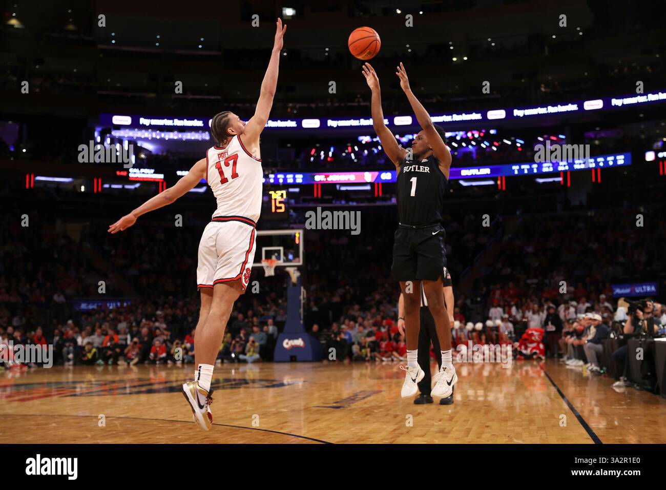 Butler guard Evan Haywood (1) shoots over St. John's forward Ruben Prey ...
