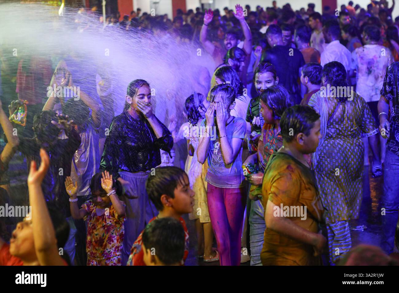 Bangkok, Thailand. 13th Mar, 2025. People dance and throw brightly ...