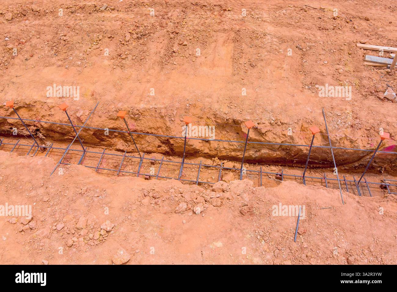 Foundation trench for building is being prepared, showcasing rebar tied ...