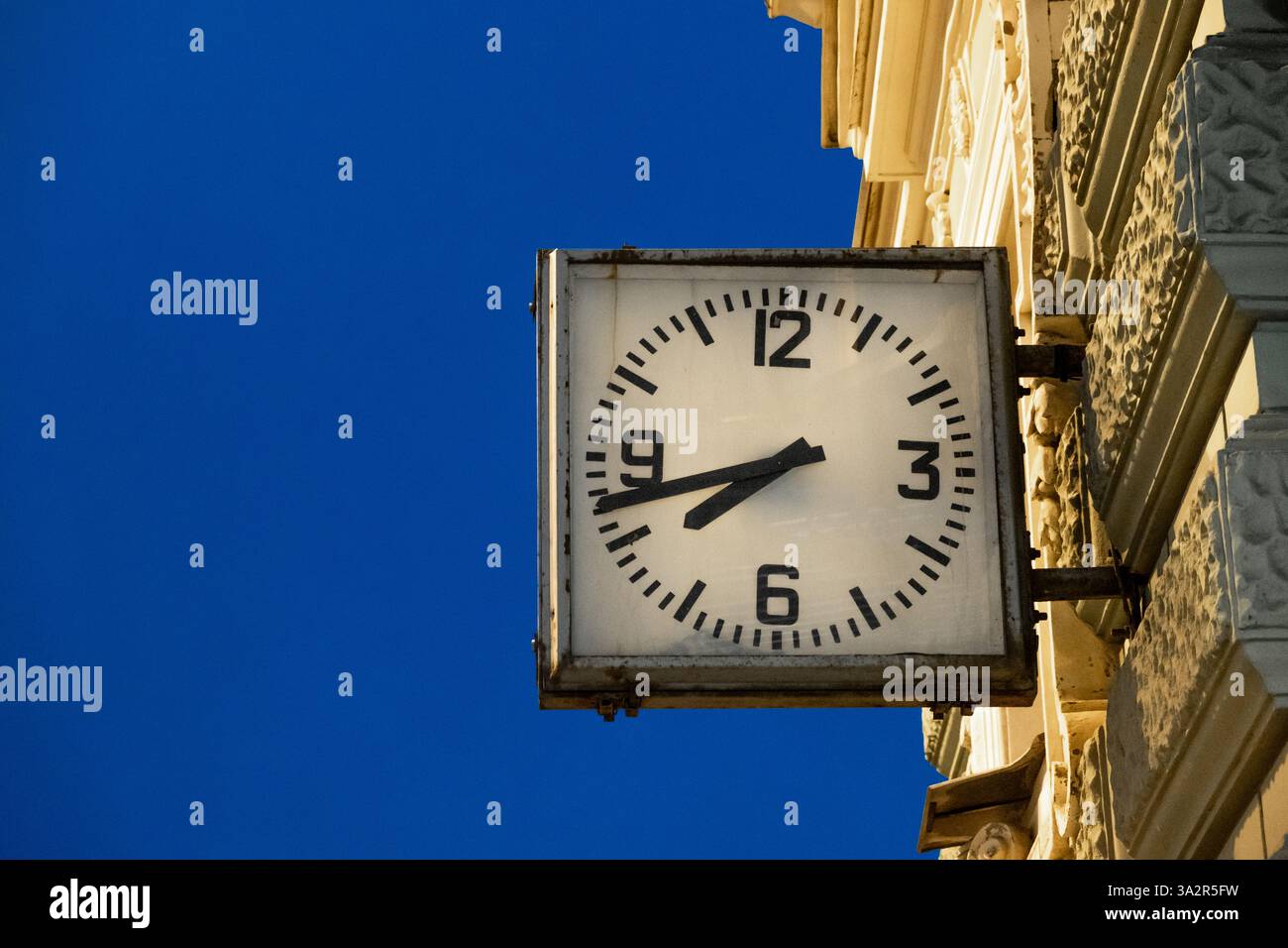 A clock mounted on a historic building in St Stock Photo - Alamy