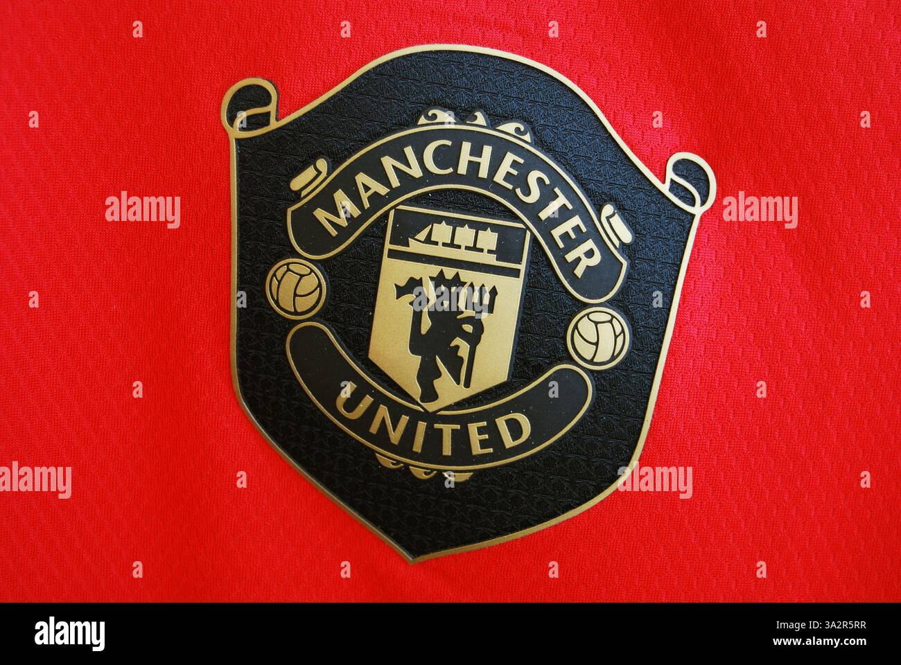 Close up photo of Manchester United FC club badge on the home shirt ...