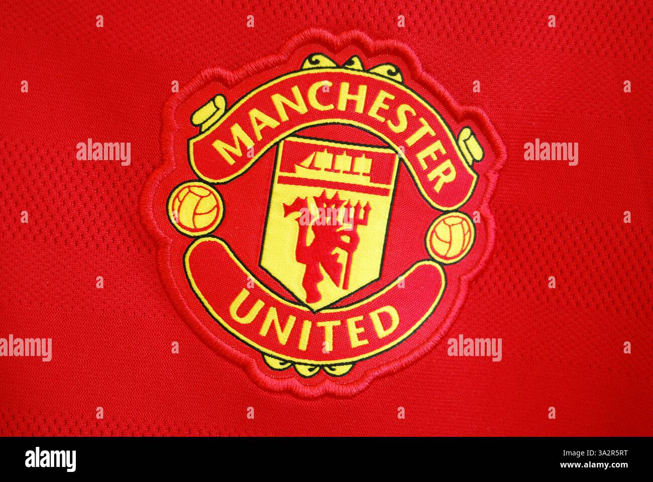 Close up photo of Manchester United FC club badge on the home shirt ...