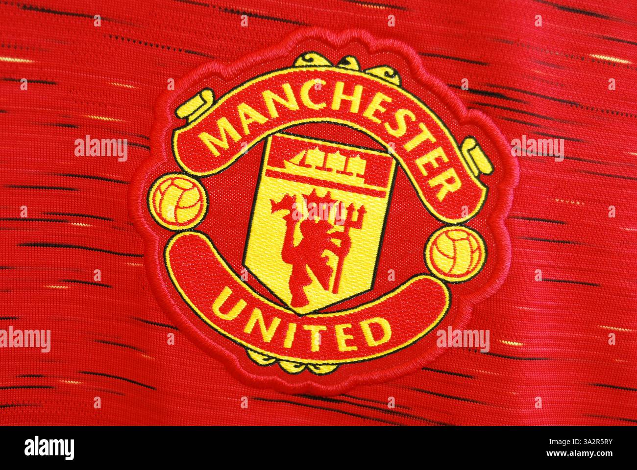 Close up photo of Manchester United FC club badge on the home shirt ...