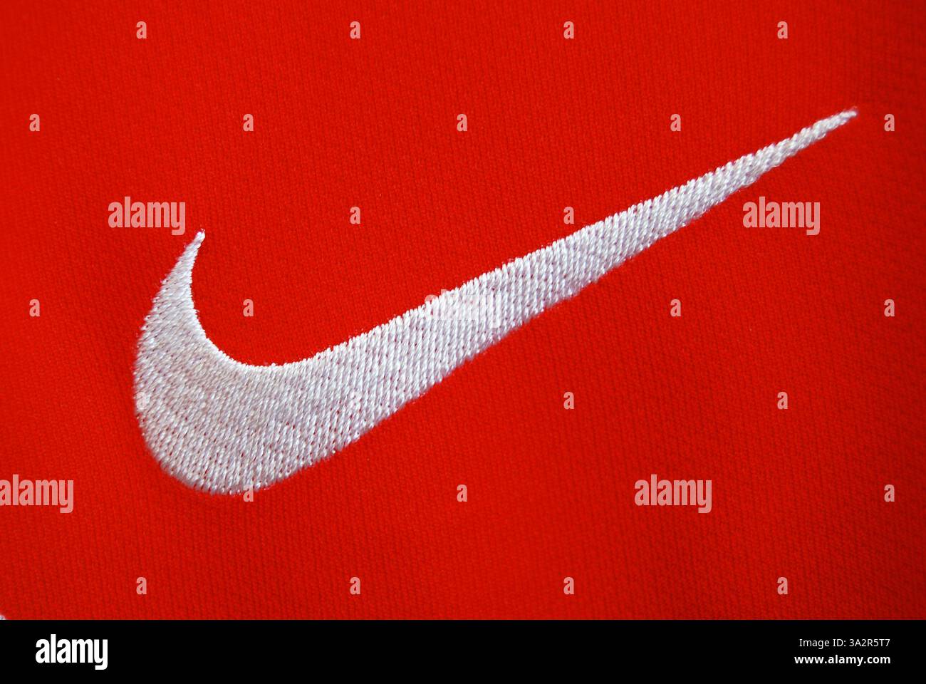 Close up photo of Nike swoosh on red football shirt Stock Photo - Alamy