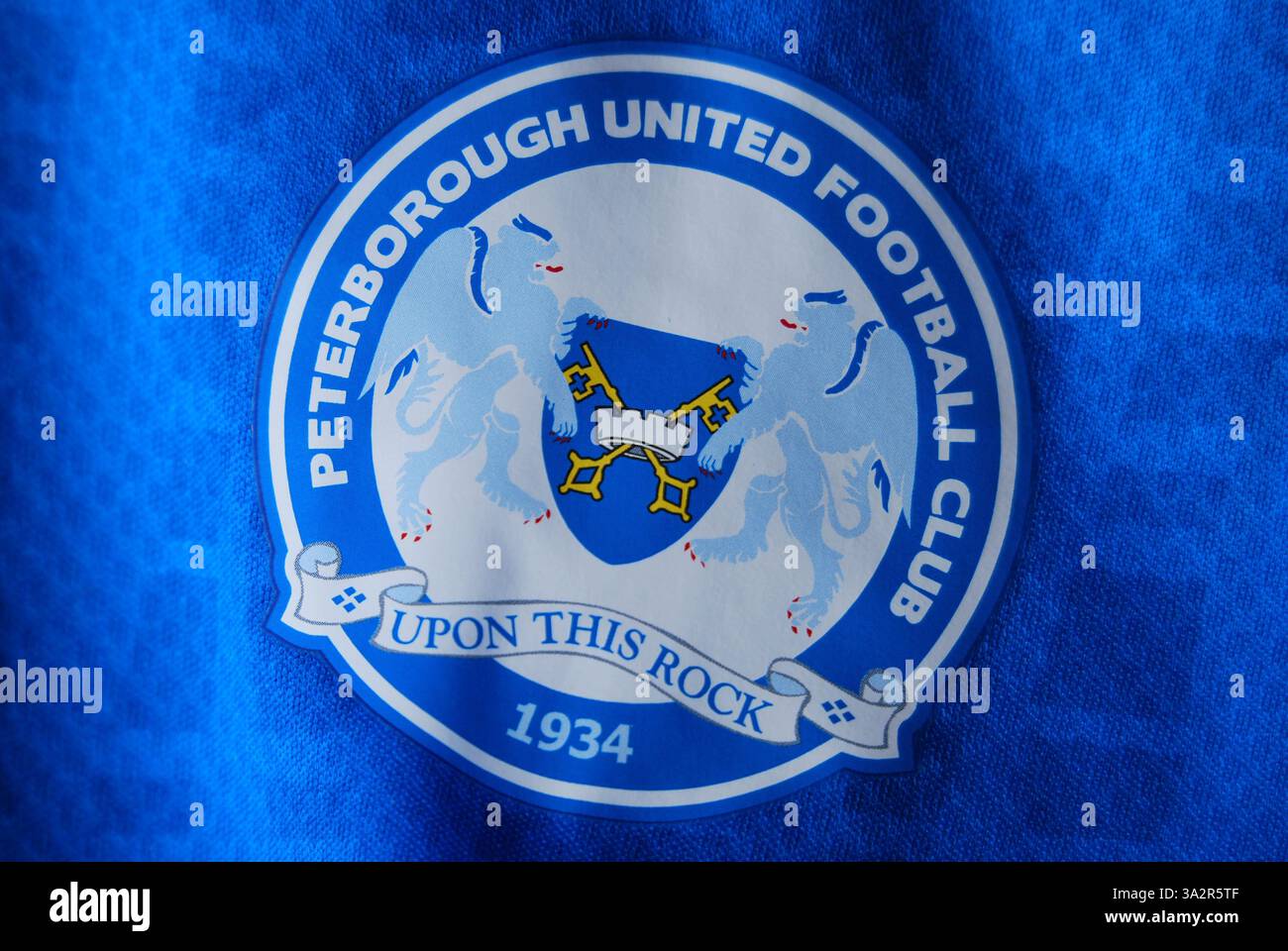 Close up photo of Peterborough United FC club badge on the home shirt ...