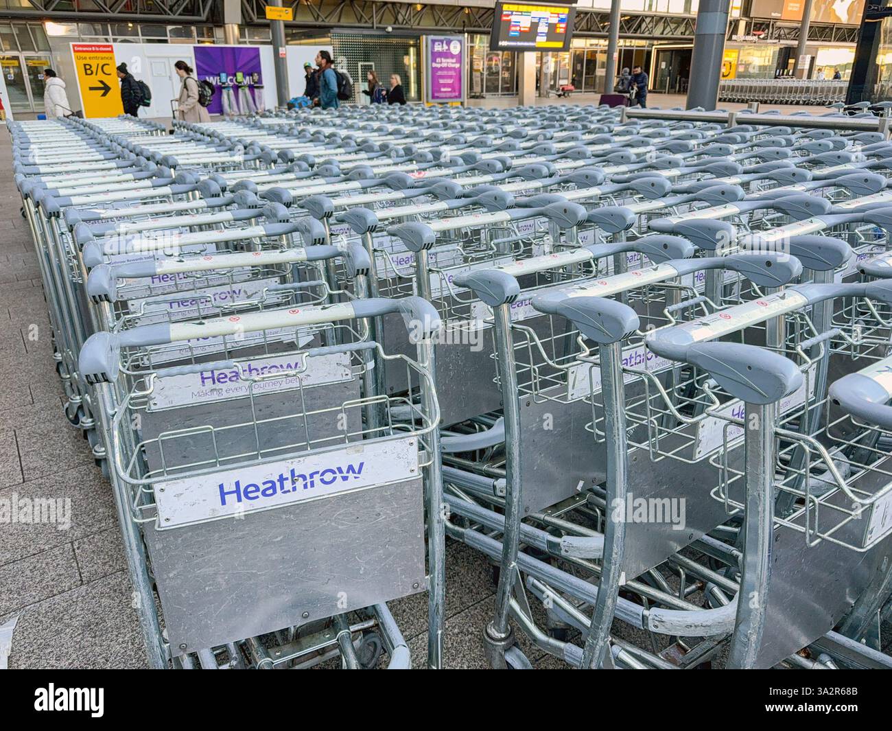 London, England, UK - 3 January 2025: Luggage trolleys outside Terminal ...