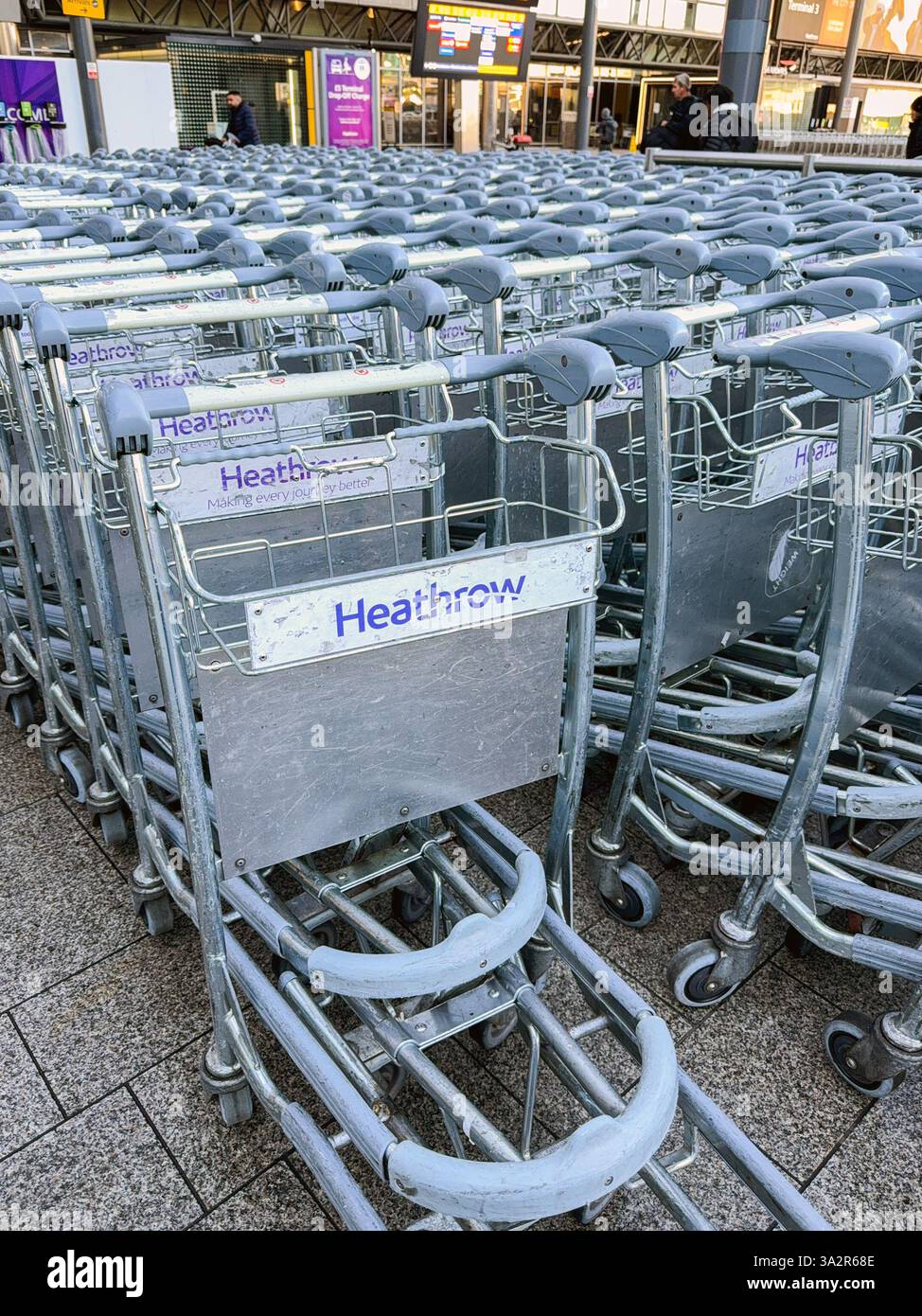 London, England, UK - 3 January 2025: Luggage trolleys outside Terminal ...