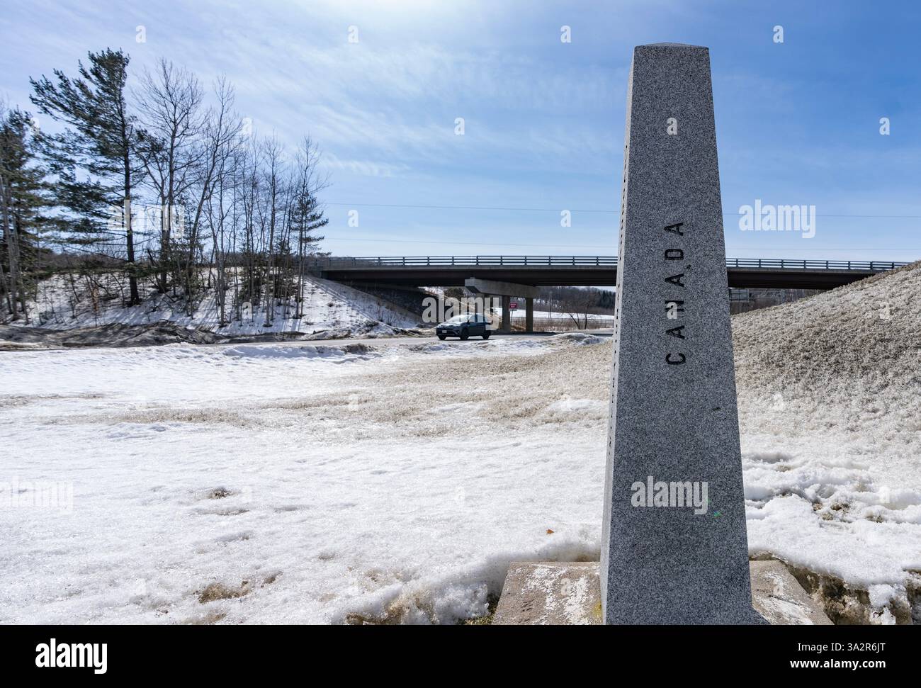 Stanstead, Canada. 13th Mar, 2025. A car passes the border marker ...
