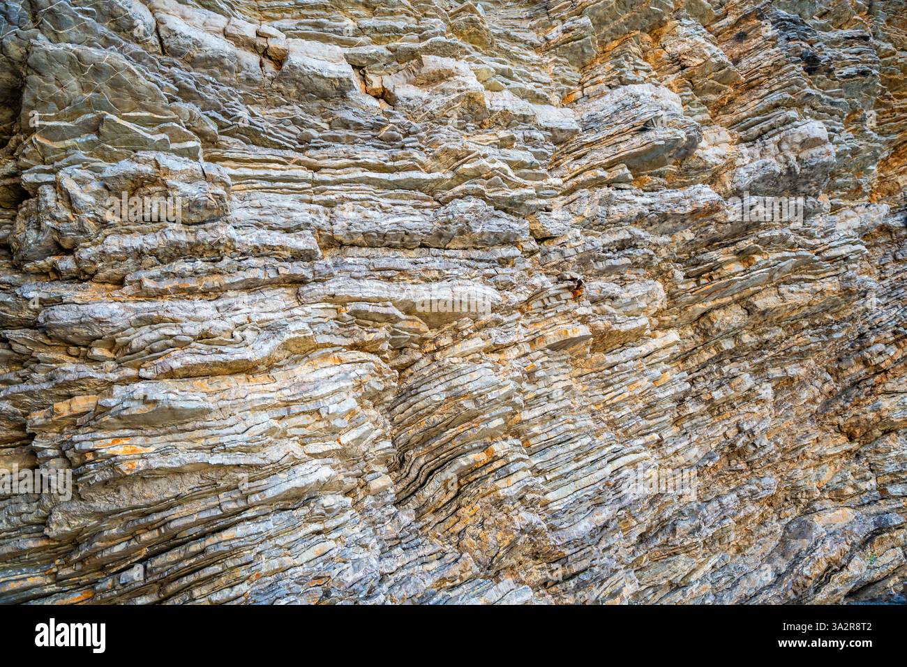Layered rock texture in Budva, Montenegro. Sedimentary rocks with ...