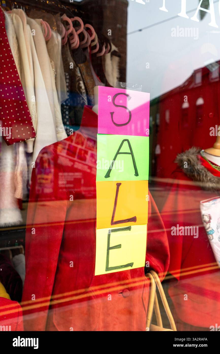 Sale sign in shop window Stock Photo - Alamy