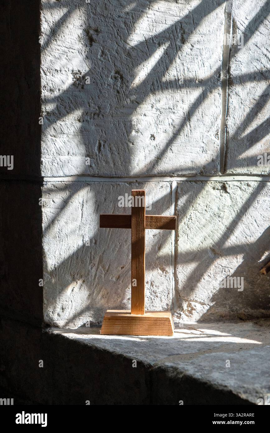 Small wooden cross in a church window with shadows Stock Photo - Alamy