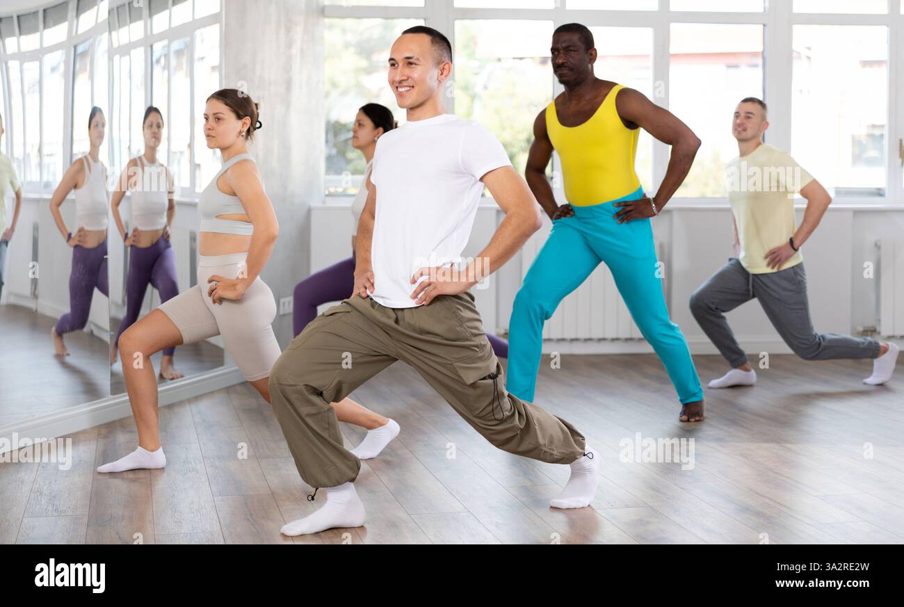Group of people warming up before dance class Stock Photo - Alamy