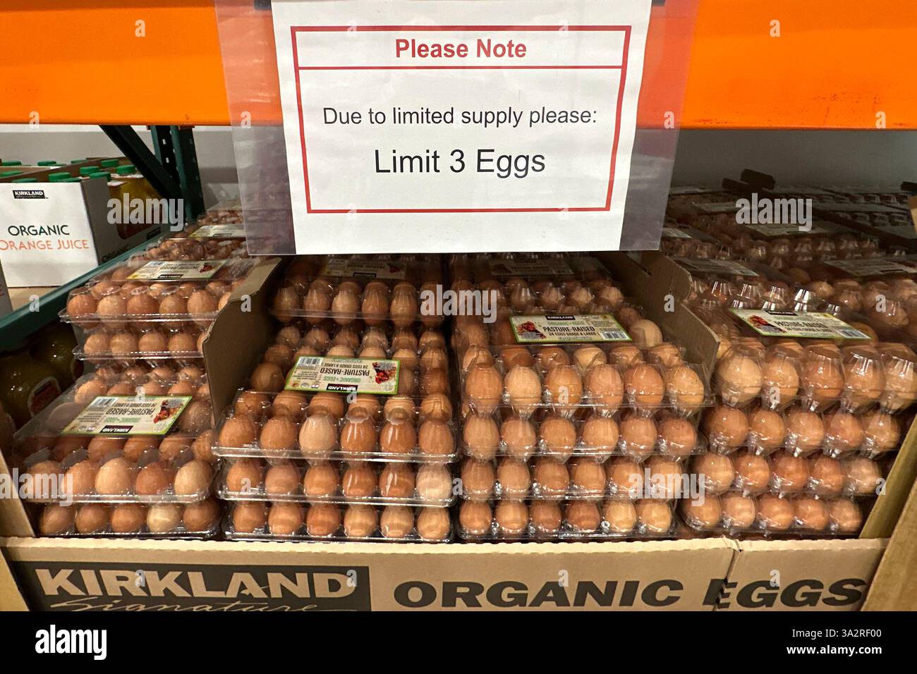 A limit sign hangs over a display of brown eggs in a Costco warehouse ...