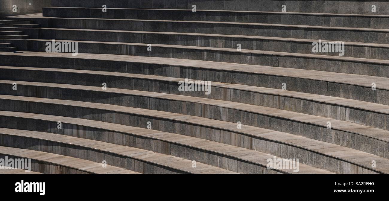 Concrete stairs or a section of a modern amphitheater with seats for ...