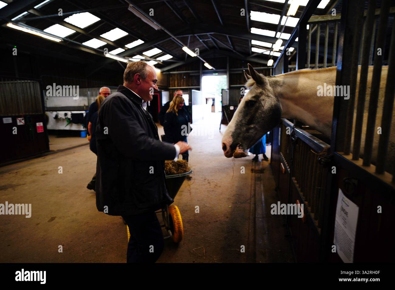 Liberal Democrat leader Sir Ed Davey meets a horse during a visit to ...