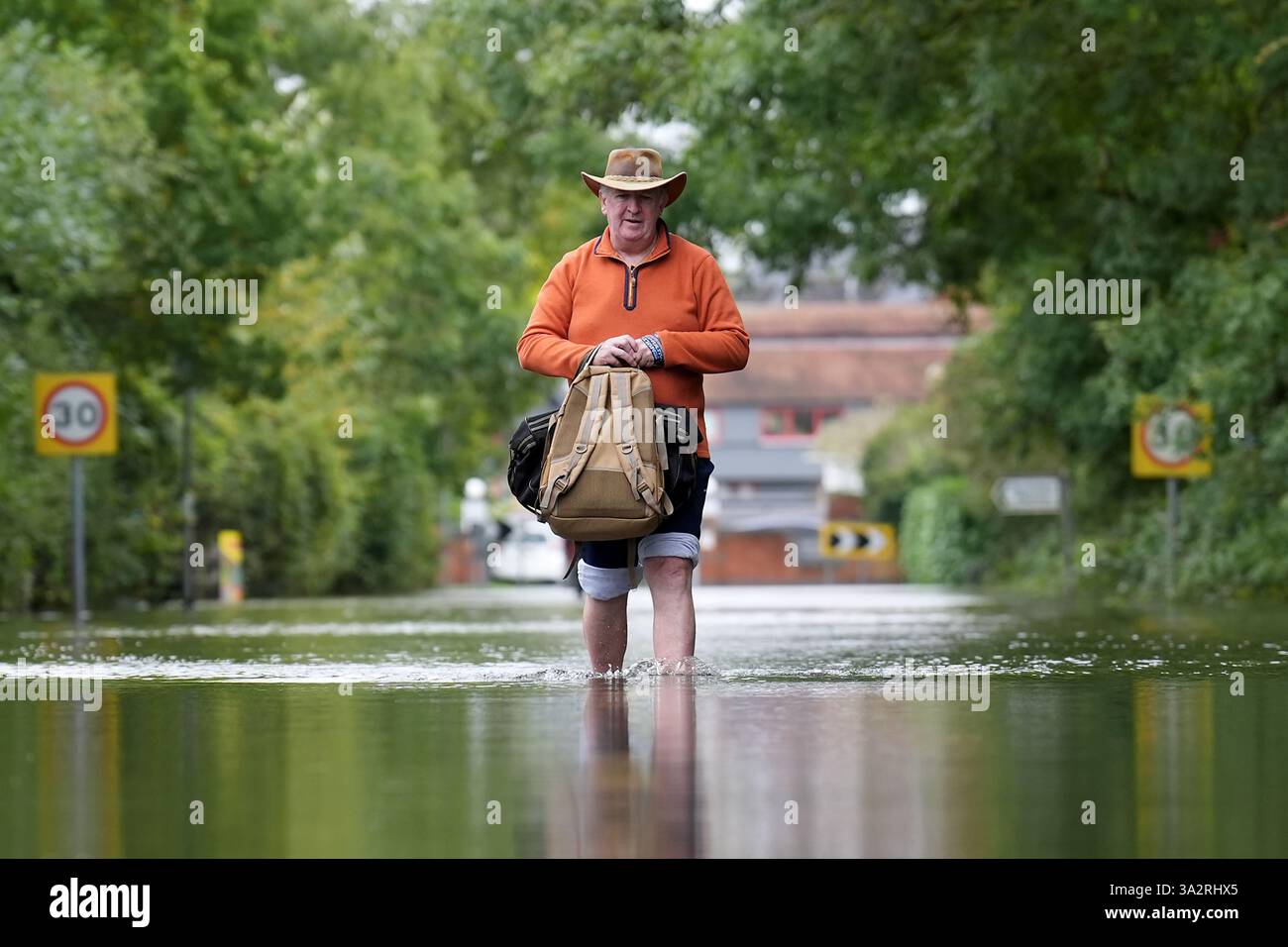 A man makes his way along a flooded road in Offord Cluny ...