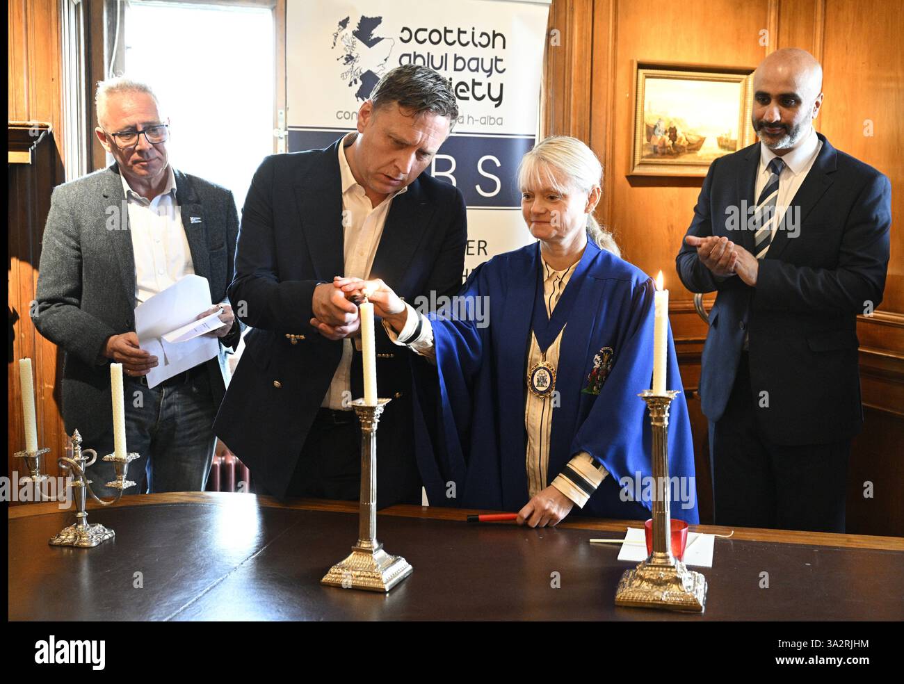 People take part in a multi-faith candle lighting ceremony at Edinburgh ...