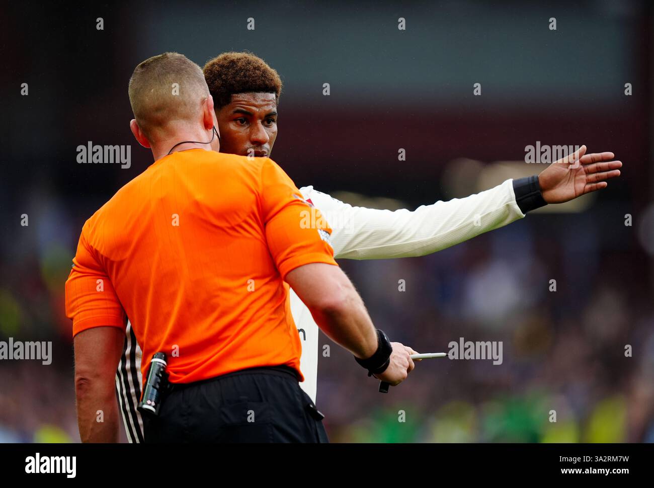 Referee Robert Jones speaks with Manchester United's Marcus Rashford ...