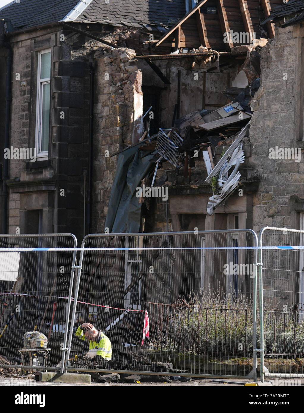 A gas worker at the scene at Kellie Place in Alloa, Clackmannanshire ...