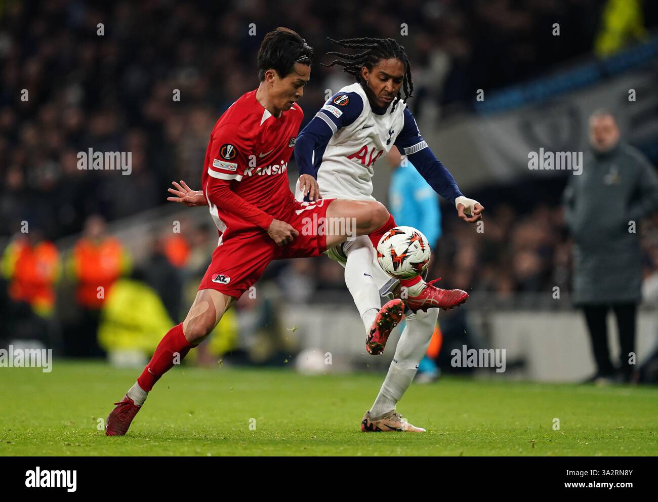 AZ Alkmaar's Seiya Maikuma (left) and Tottenham Hotspur's Djed Spence ...