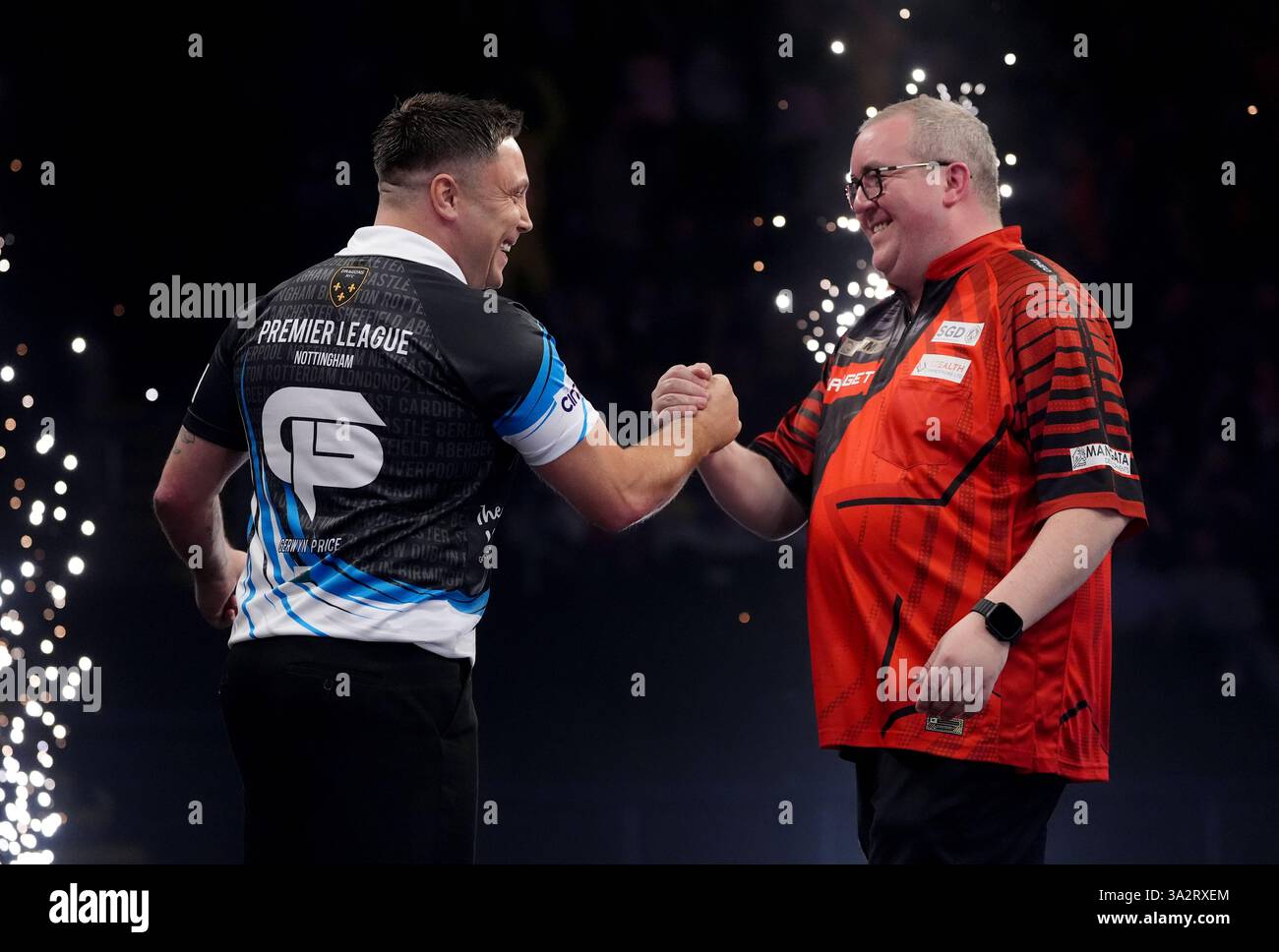 Gerwyn Price and Stephen Bunting embarce during night six of the BetMGM ...